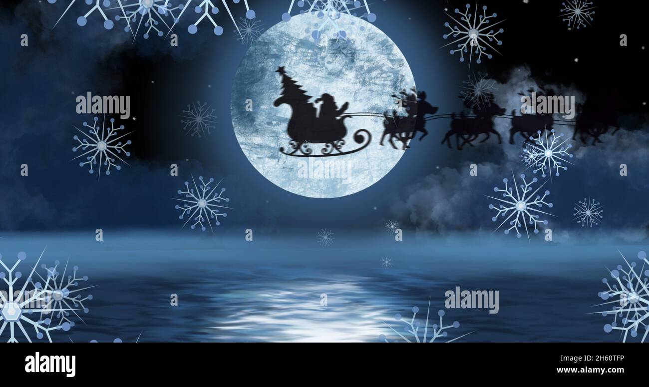 Image of snow falling over santa in sleigh at christmas Stock Photo - Alamy