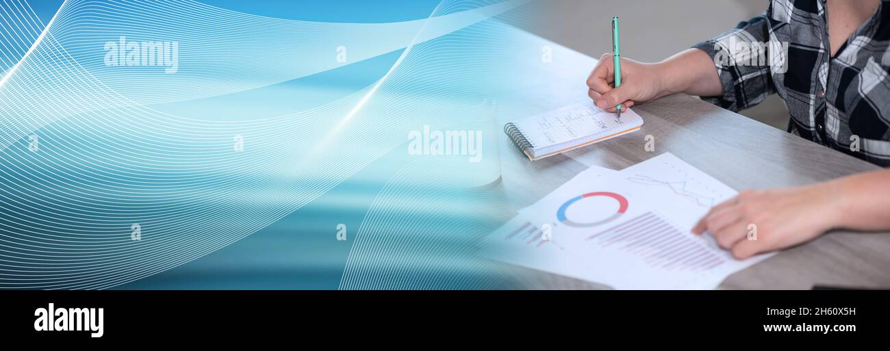 Businesswoman analysing marketing data and taking notes; panoramic ...