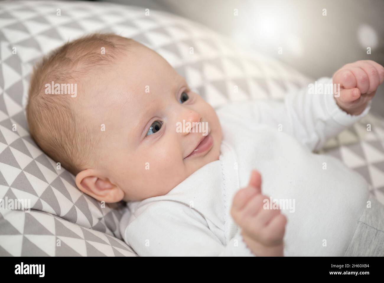 Portrait of smiling baby lying on back Stock Photo - Alamy