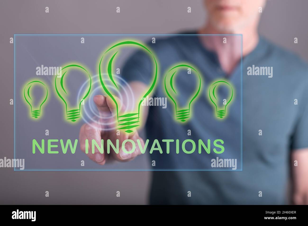 Man touching a new innovations concept on a touch screen with his ...