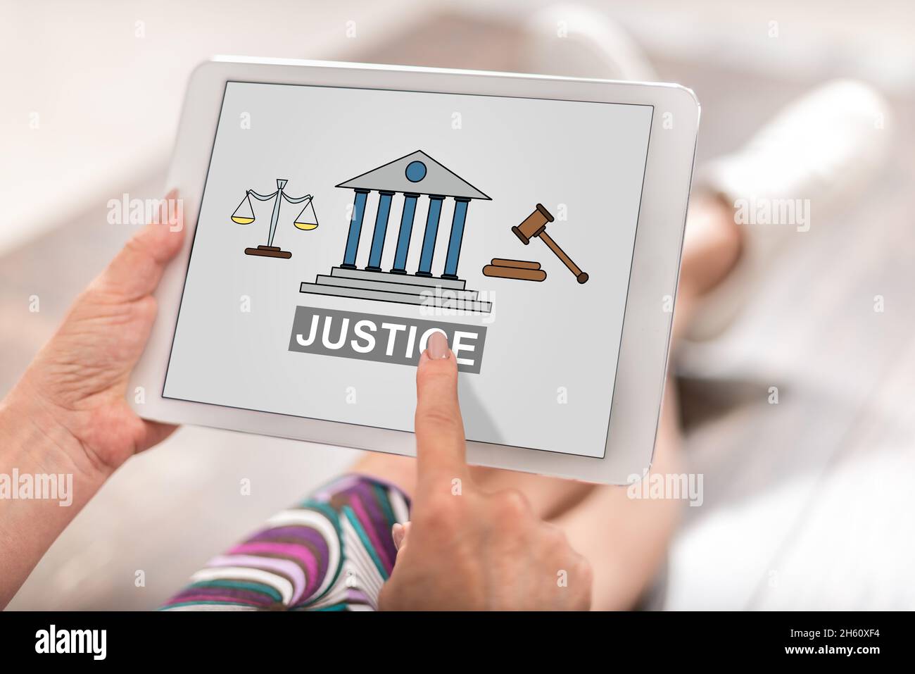Woman using a tablet with justice concept Stock Photo - Alamy