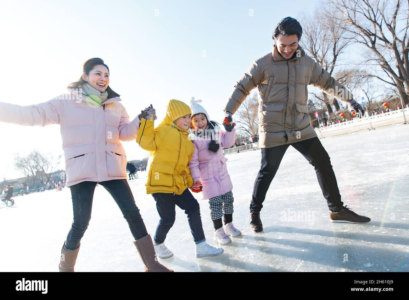 Skating happy family hand in hand Stock Photo - Alamy
