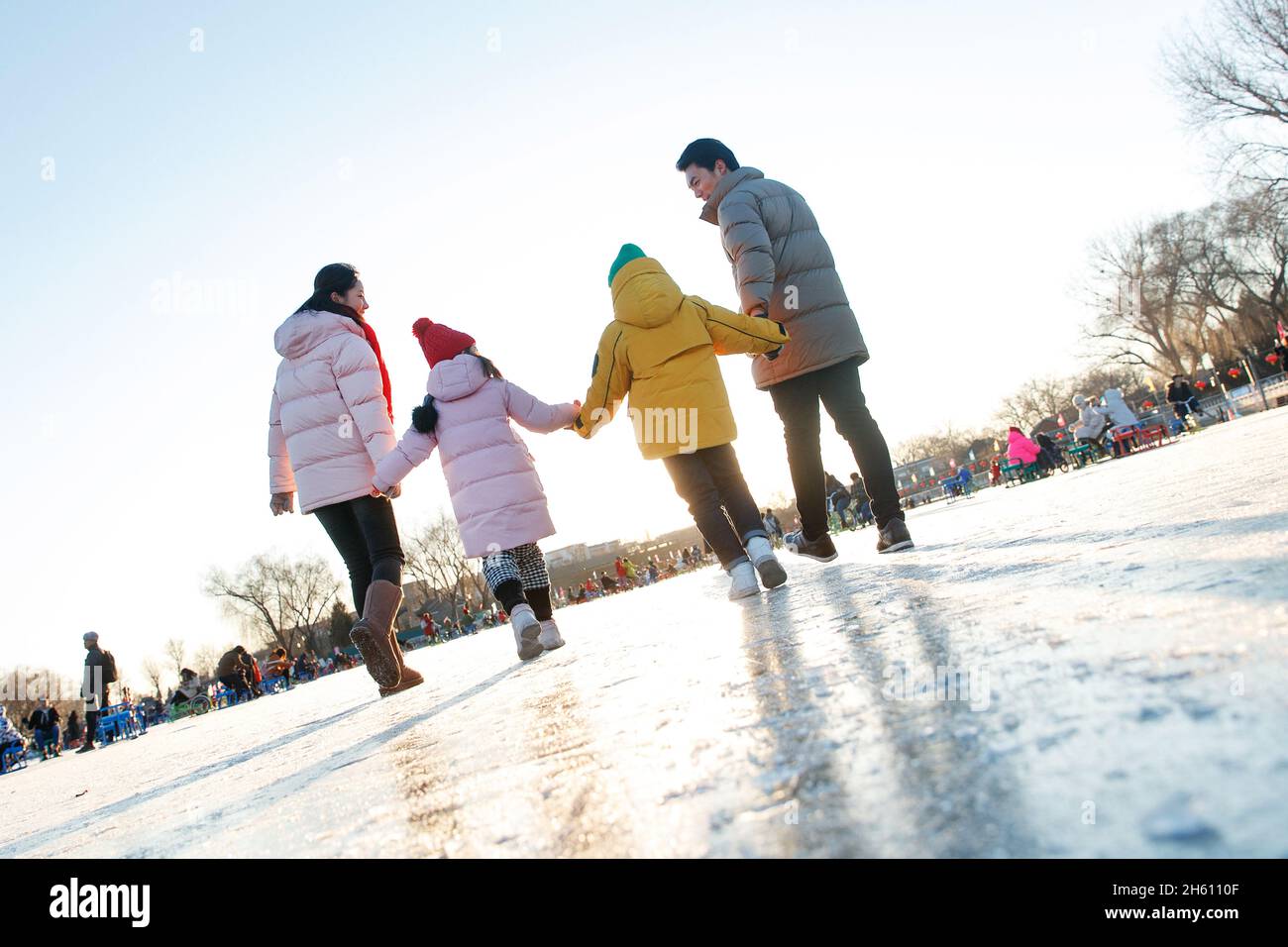 Skating happy family hand in hand Stock Photo - Alamy