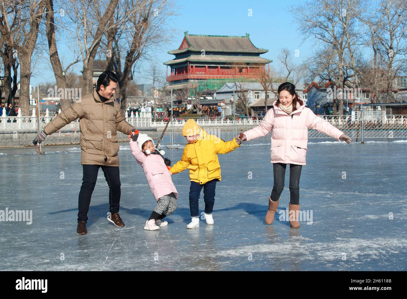 Happiness skating family hand in hand Stock Photo - Alamy