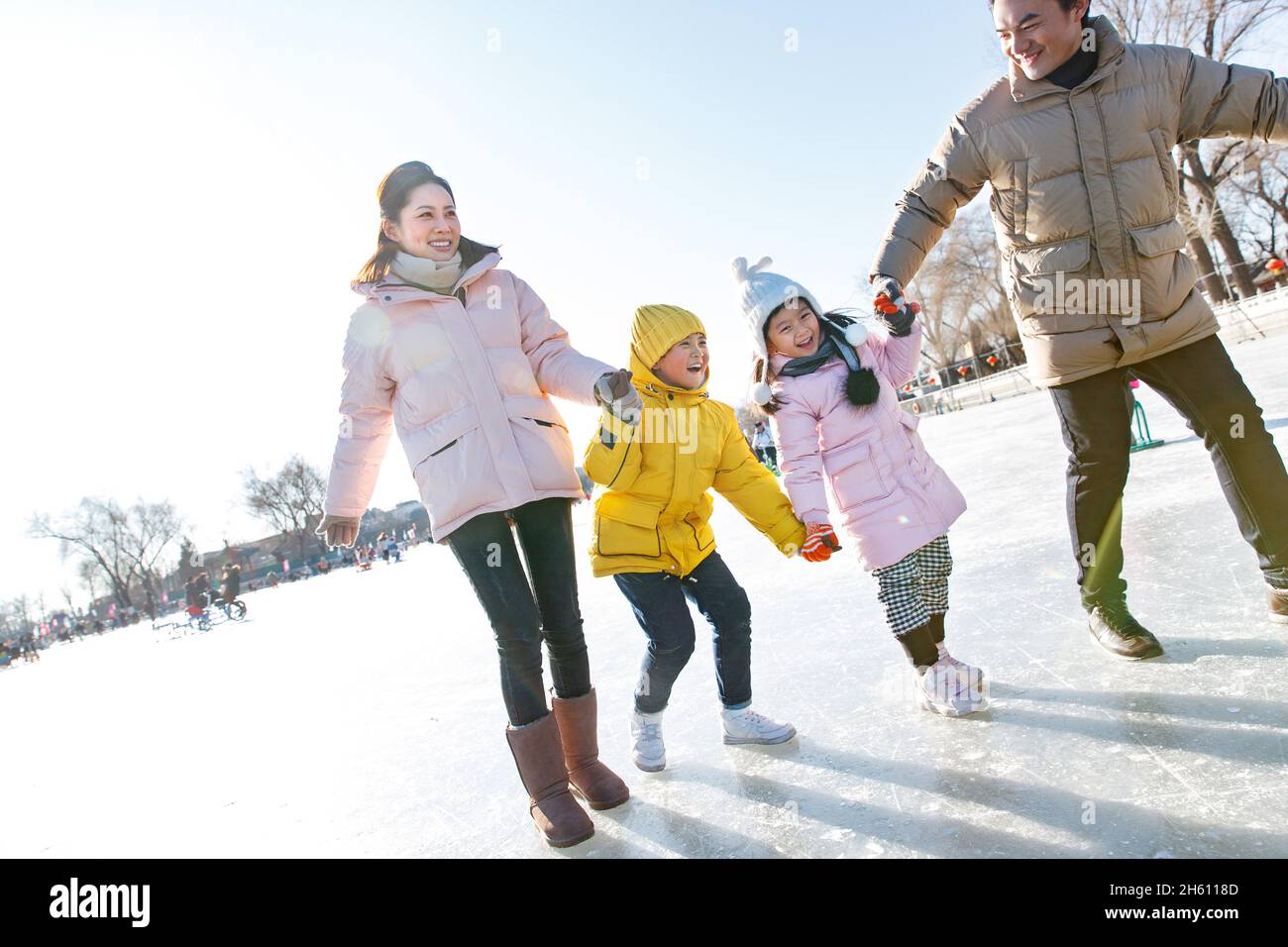 Happiness skating family hand in hand Stock Photo - Alamy