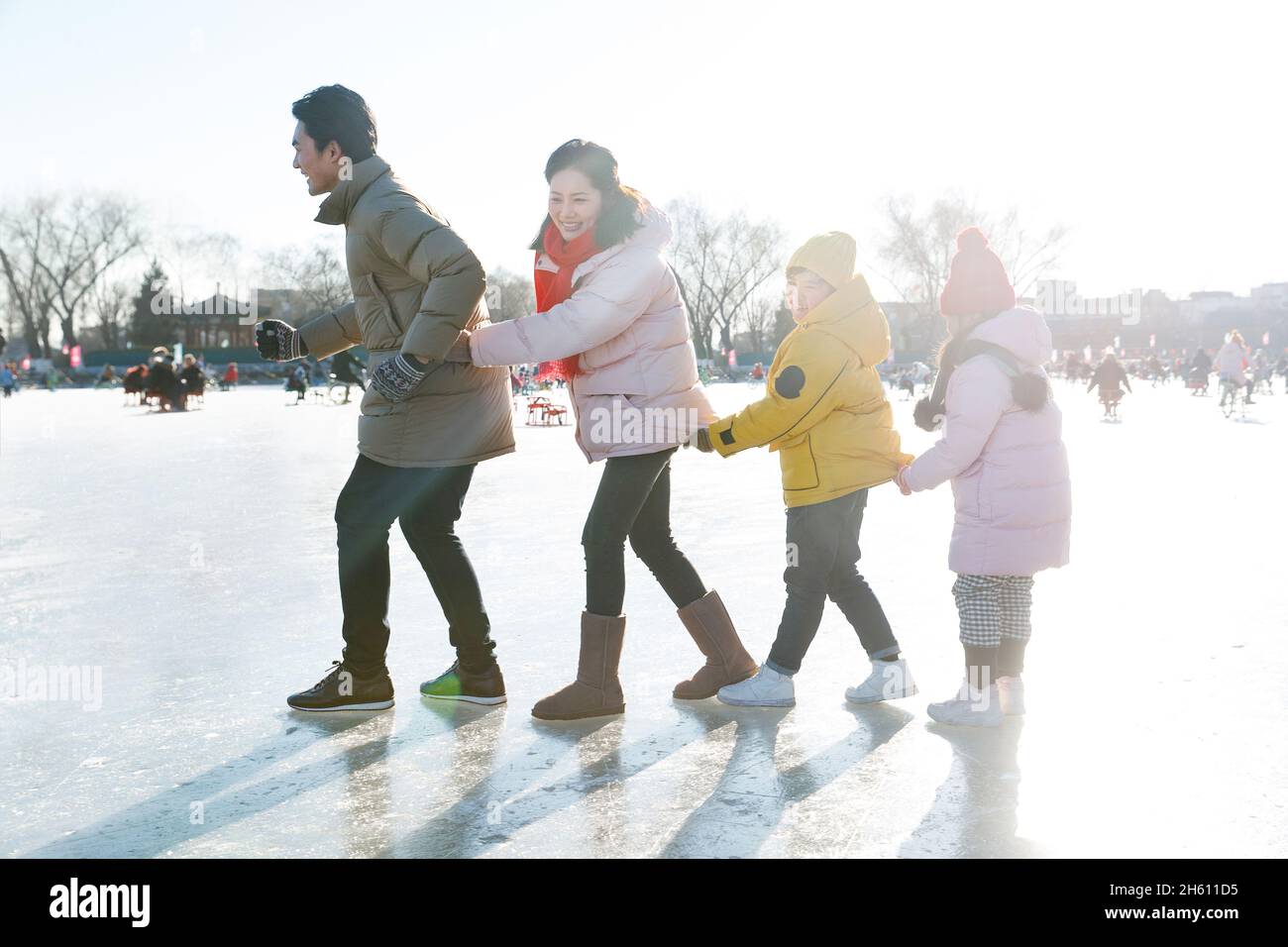 A happy family in the skating rink Stock Photo - Alamy