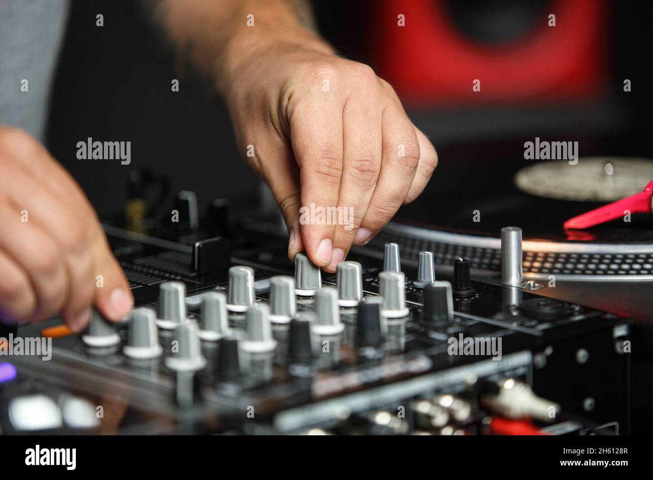 Concert dj mixing music with sound mixer device on stage in night club ...