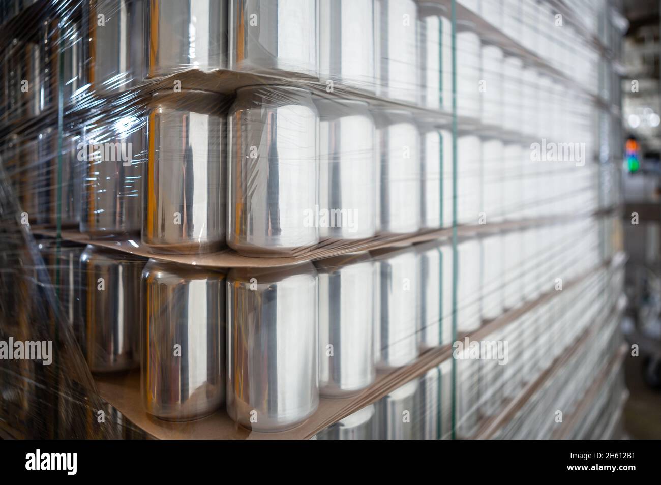 New beer cans stacked in warehouse. Empty aluminum can storage in ...