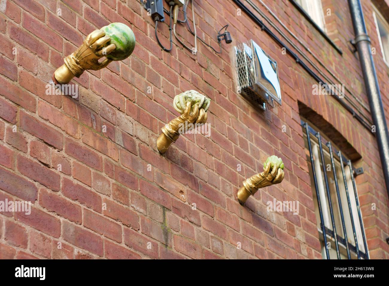 Hands on the side of the buildings along the alleys of Falcon Yard ...