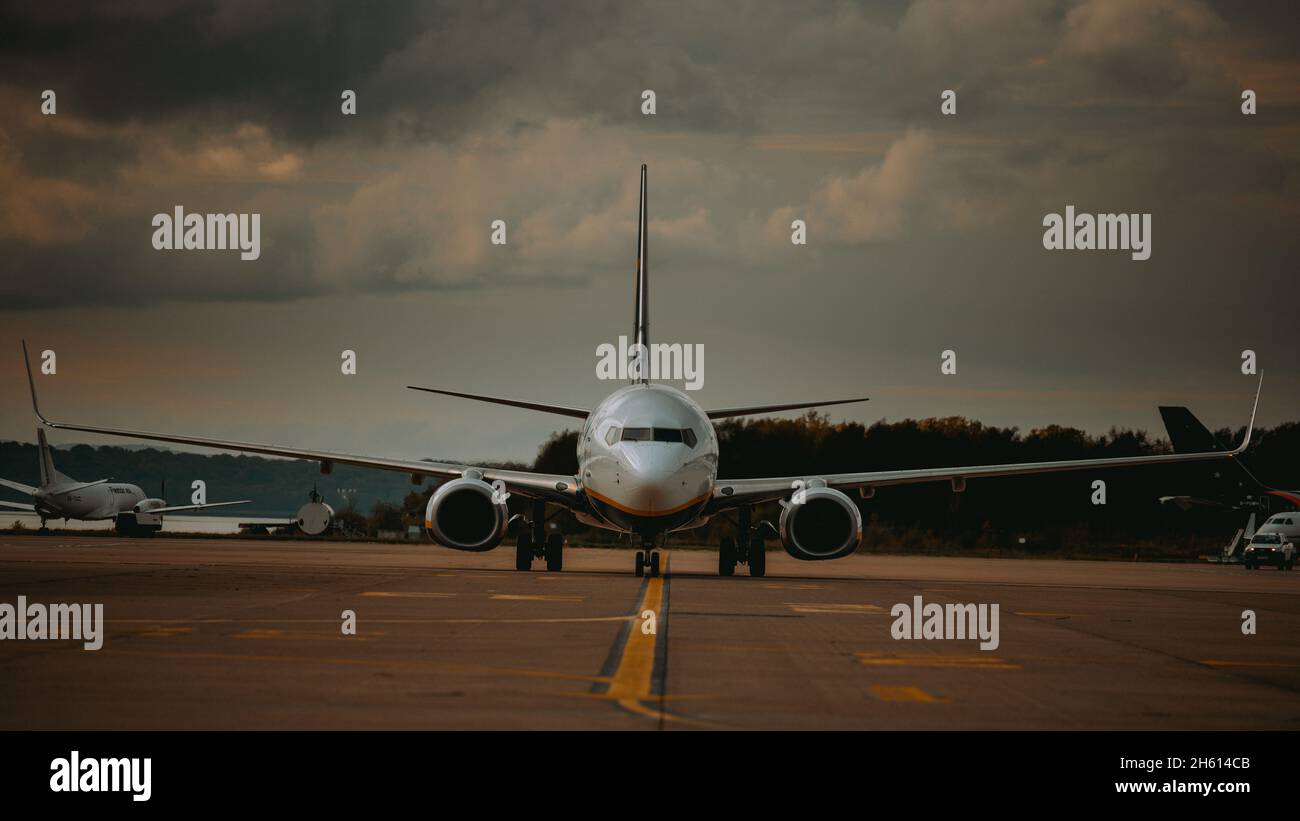 Plane landing at the airport. Front view Stock Photo - Alamy