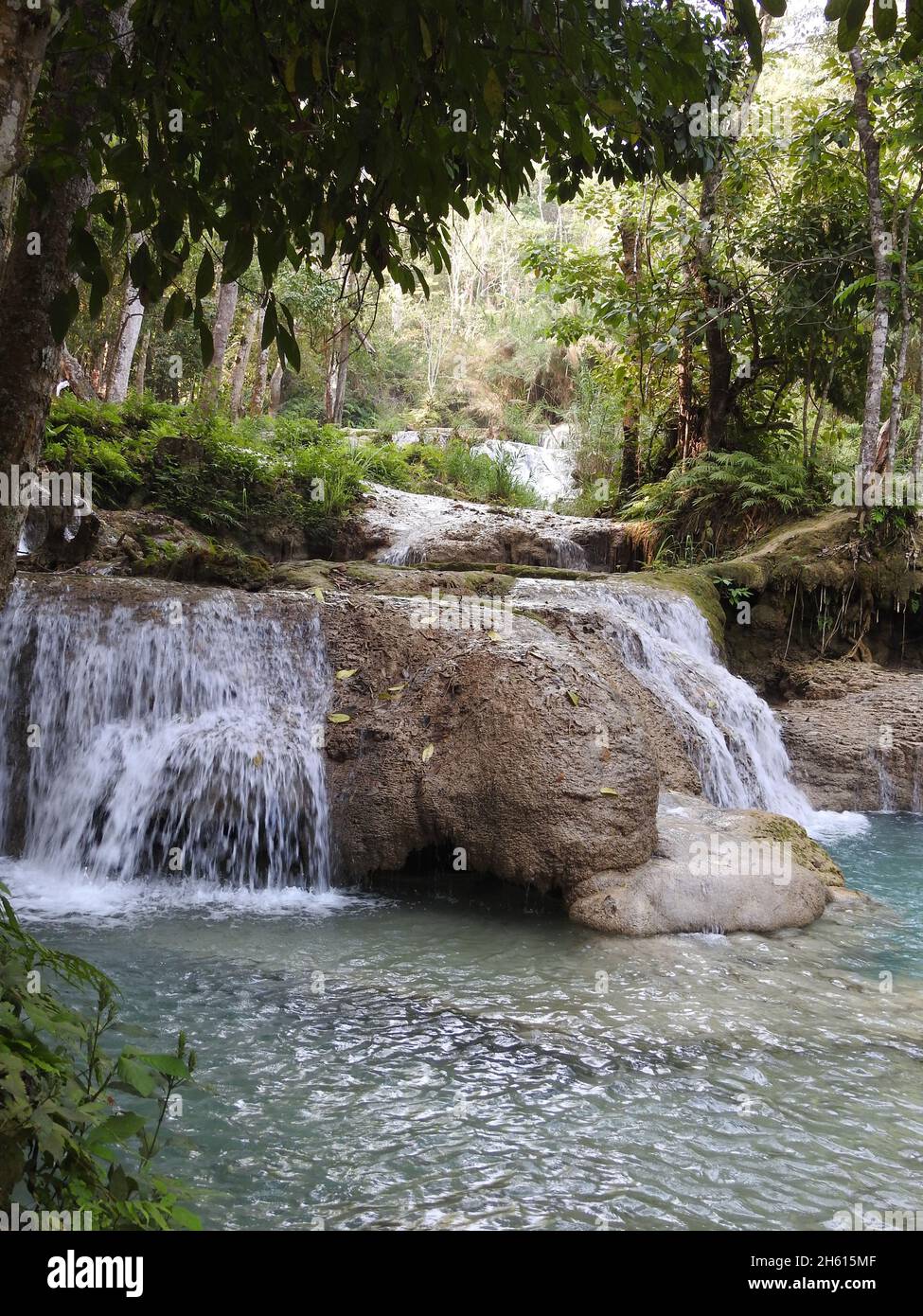 Flipped vertical shot of the scenic Kuang Si Waterfall (Kuang Xi Falls ...