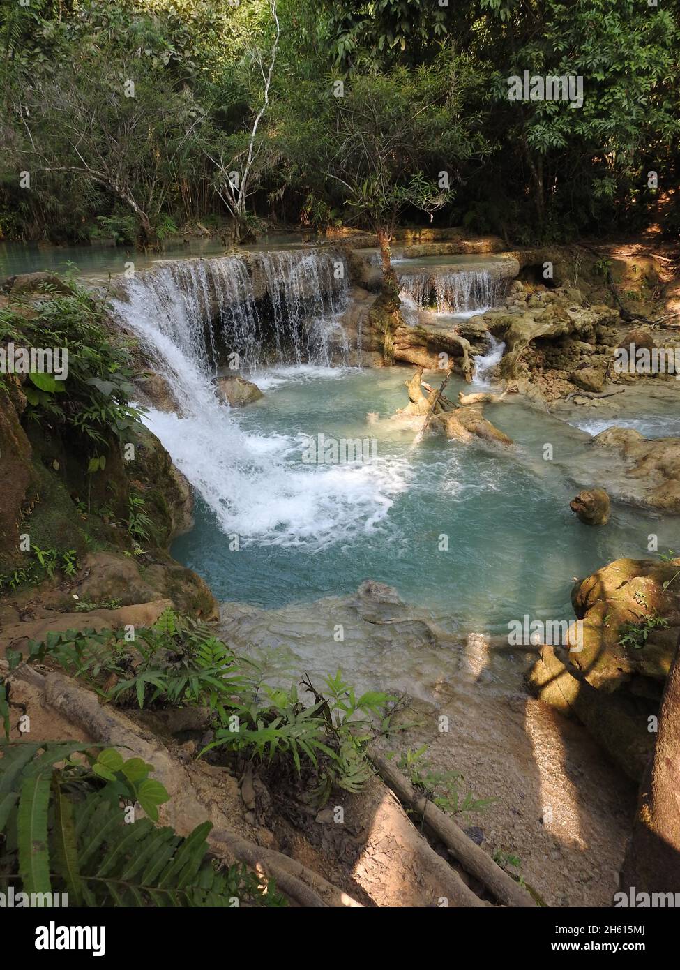Flipped vertical shot of the scenic Kuang Si Waterfall (Kuang Xi Falls ...