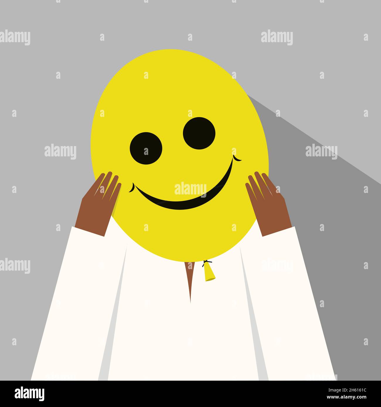 A person covering the face with an inflated balloon with smile symbol ...