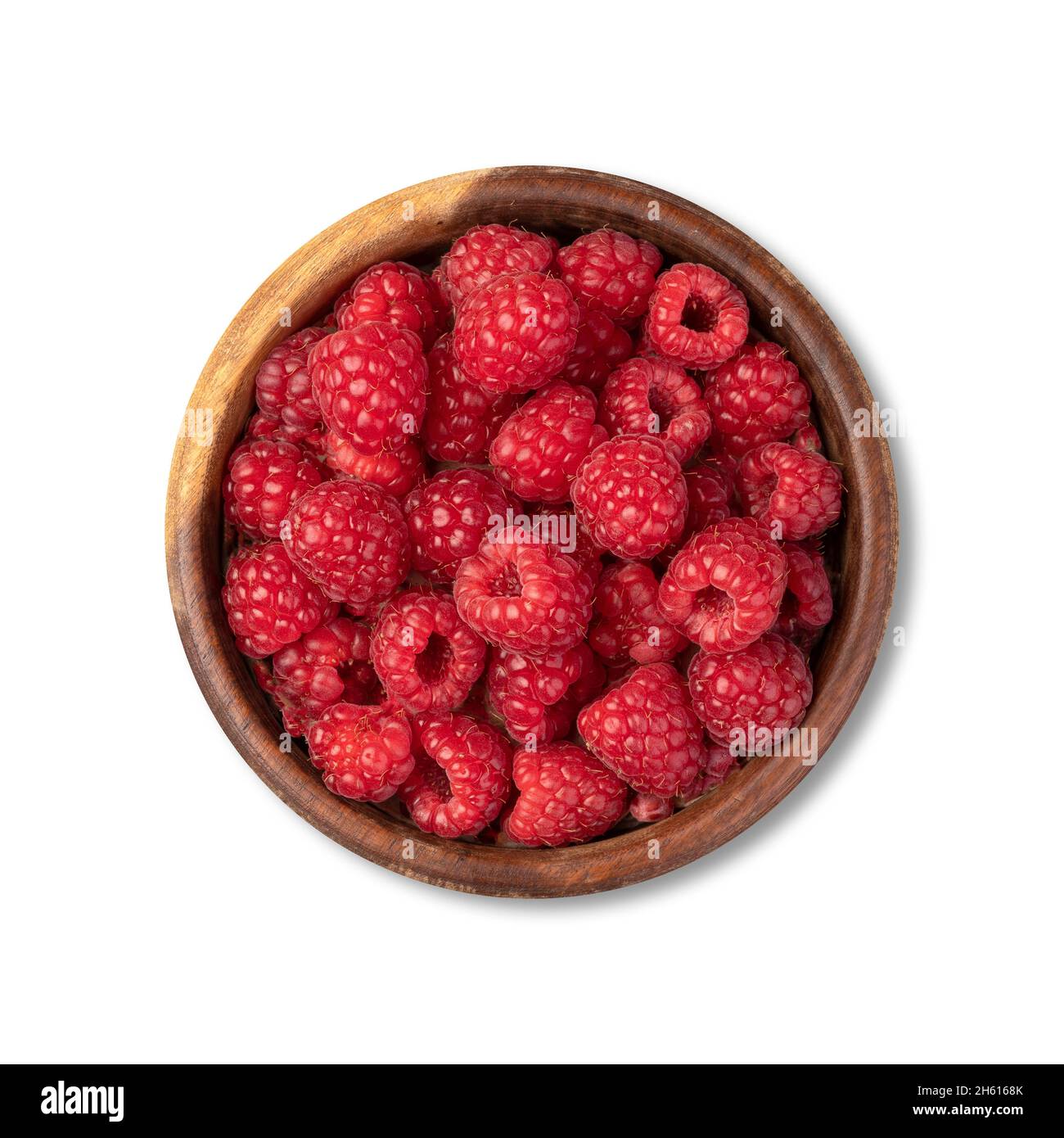 Raspberries in a bowl isolated over white background Stock Photo - Alamy