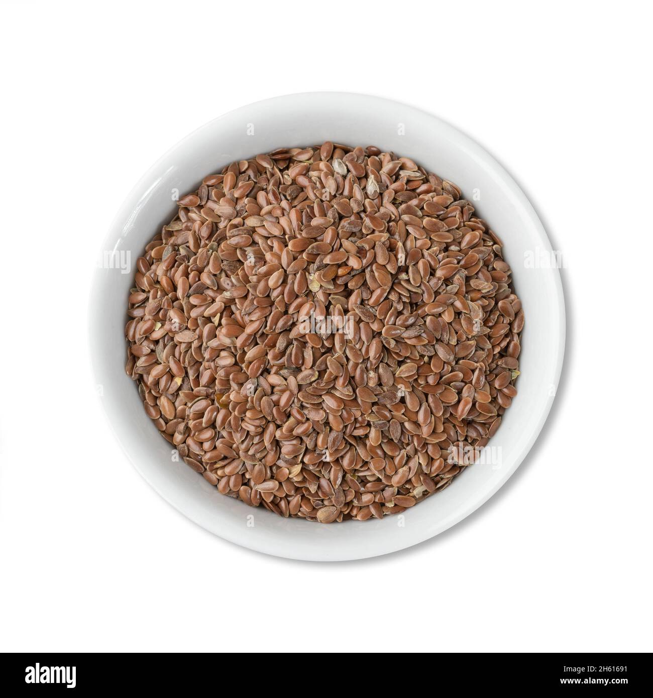Brown linseed on a bowl isolated over white background Stock Photo - Alamy