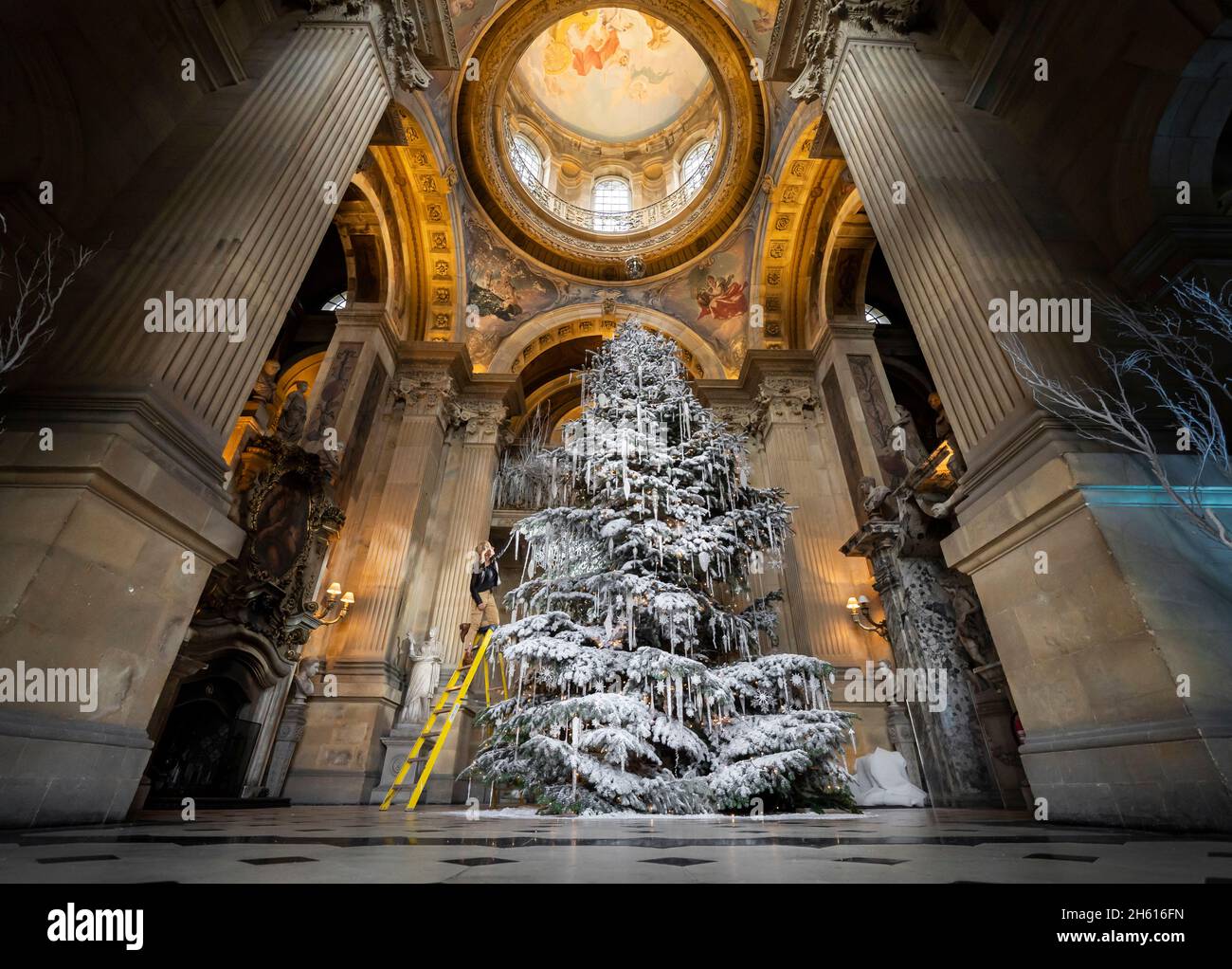 Bretta Gerecke puts the finish touch to a Christmas tress in the Great ...