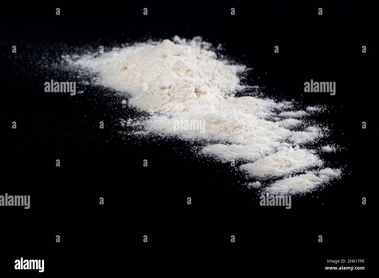 Sprinkled wheat flour splash spots on a black background Stock Photo ...