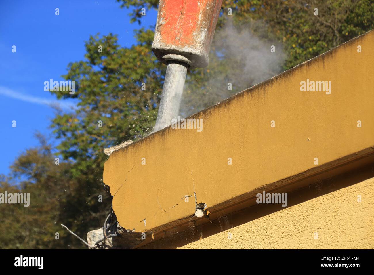 Demolition of a ceiling with a large chisel Stock Photo - Alamy
