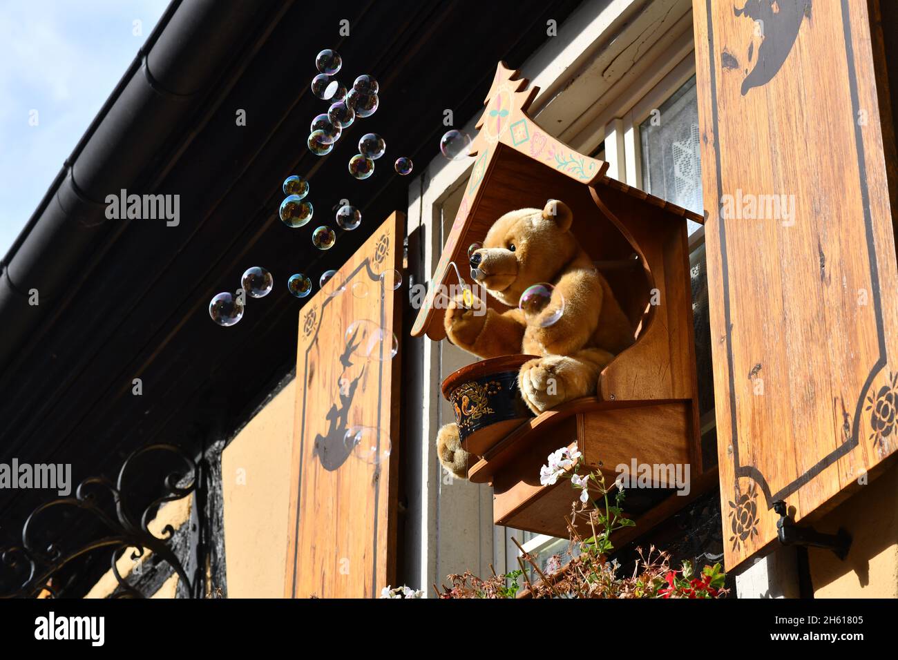 Toy Teddy bear blowing soap bubbles at Ribeauville village in Alsace ...