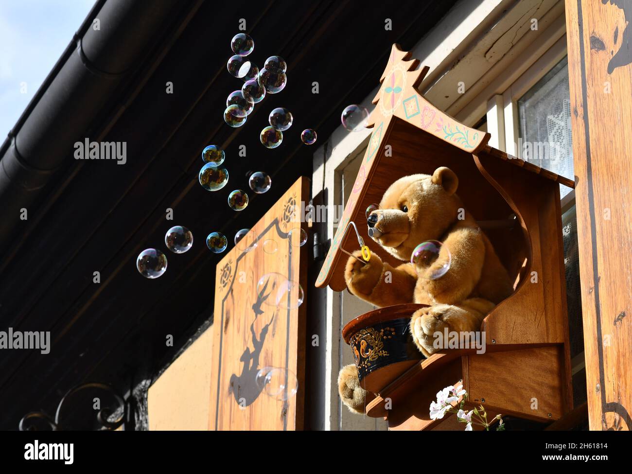Toy Teddy bear blowing soap bubbles at Ribeauville village in Alsace ...