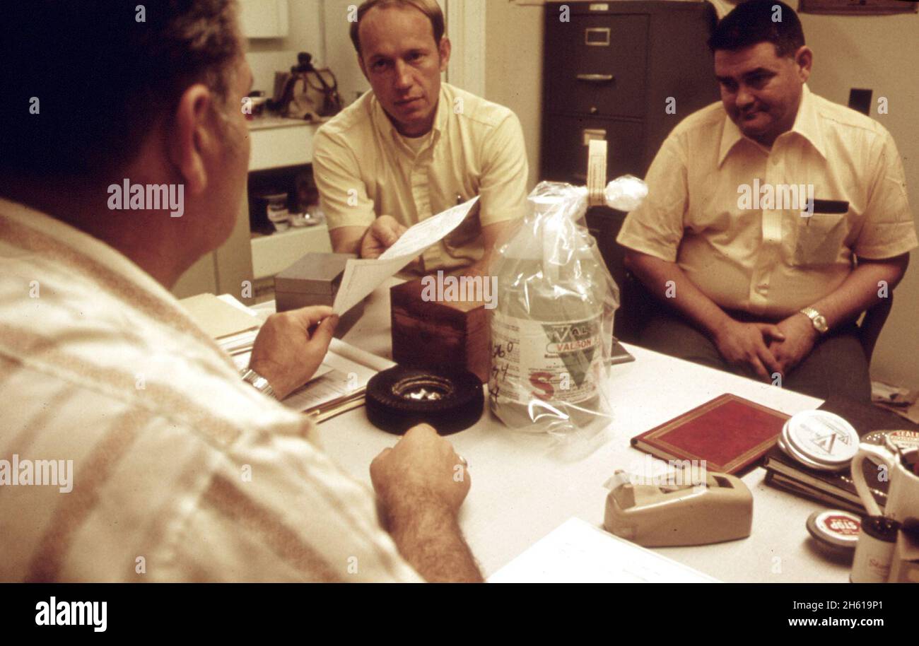 An environmental protection agency pesticides inspector hands a receipt ...