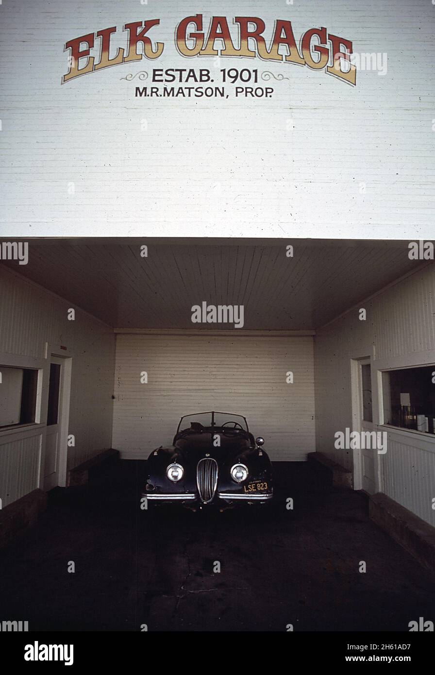 1970s America: Old car sitting in the Elk Garage in a small northern ...
