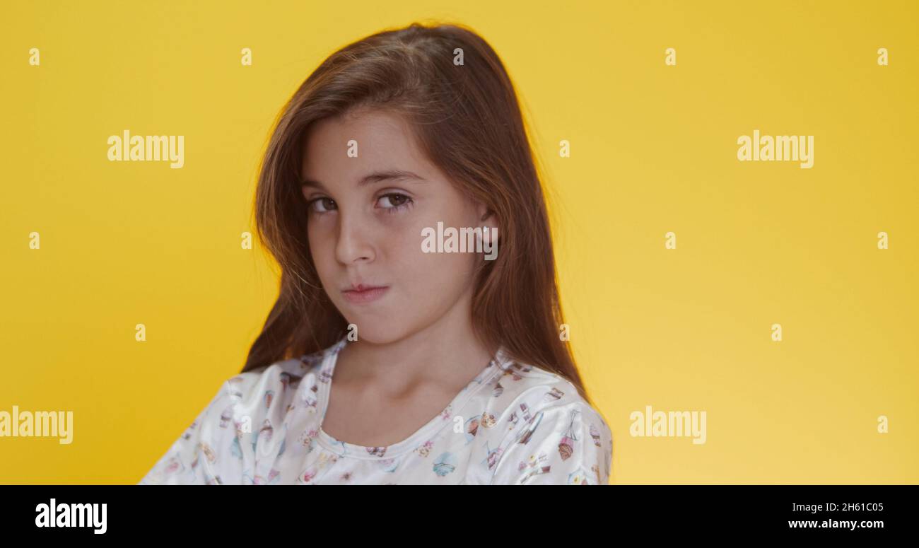 Child tantruming crossing the arms. On yellow background Stock Photo ...