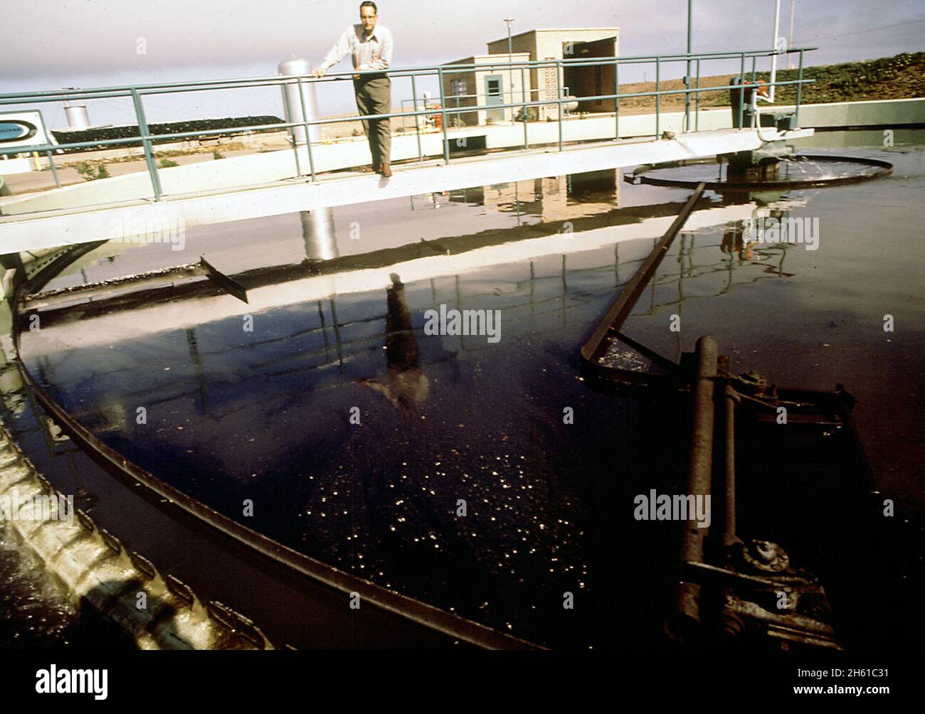 1970s America: California sewage treatment plant. Oil deposits are from ...