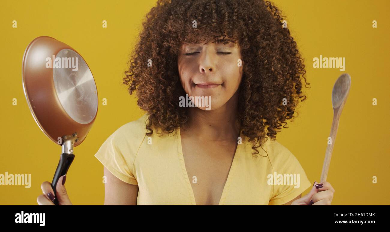 Cooking utensils. Cooking woman in kitchen with frying pan and wooden ...