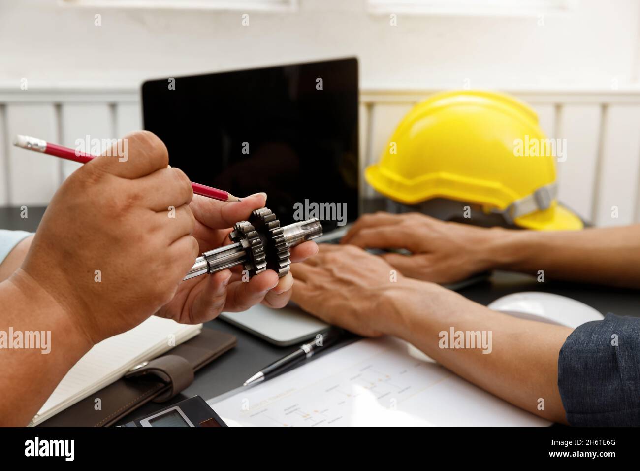 The engineering team is working on their project together. Man work ...