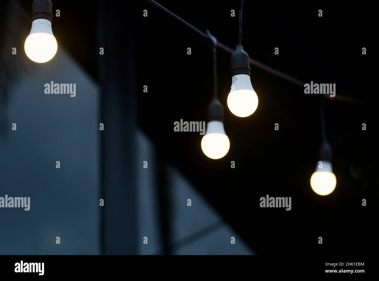 Closeup shot of burning light bulbs hanging on the ceiling Stock Photo ...