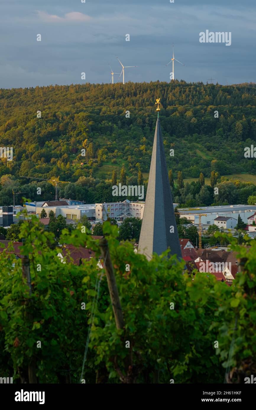 Church steeple and wind turbines in morning light cityscape Stock Photo ...