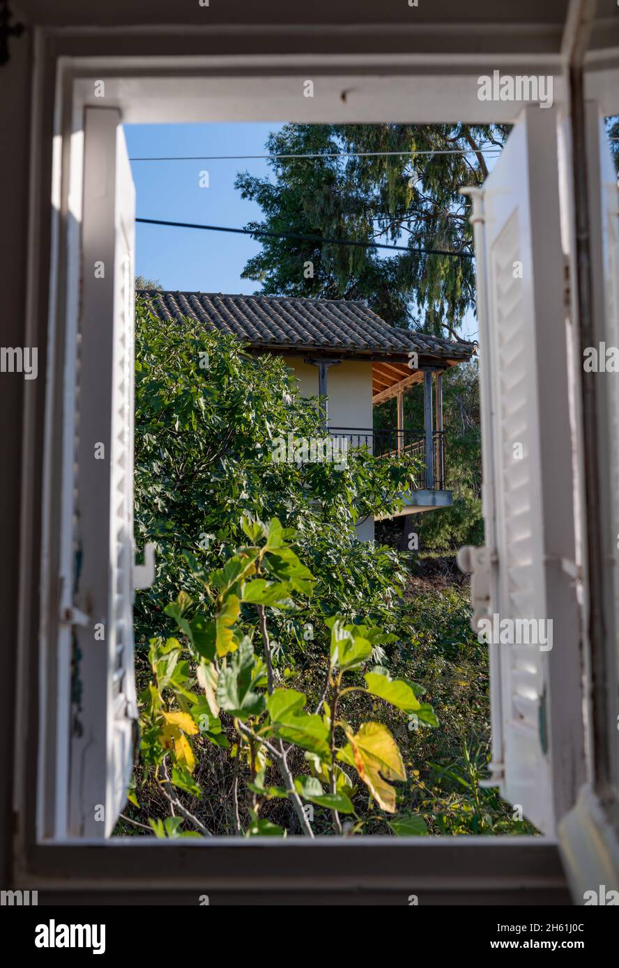 A view through a old wooden window with shutters Stock Photo - Alamy