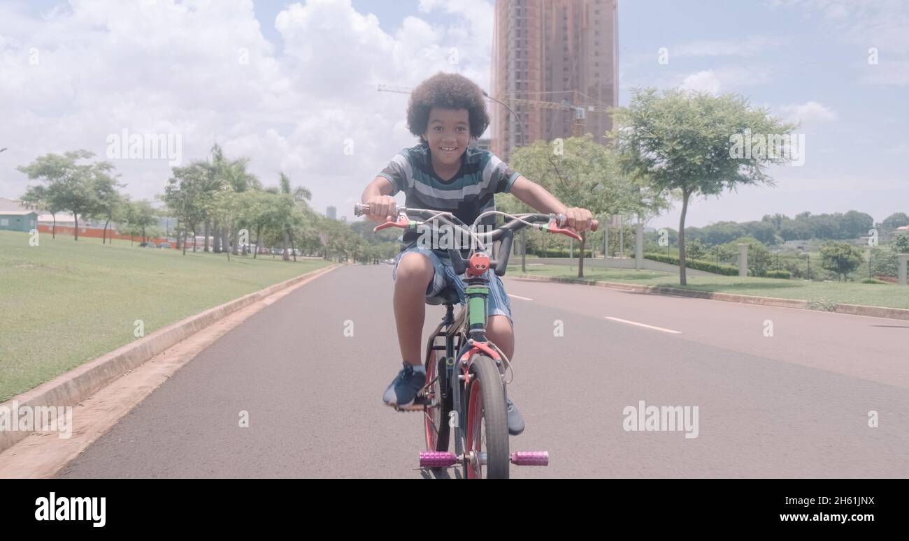 Happy cute boy riding a bike. Ride bicycle at park Stock Photo - Alamy