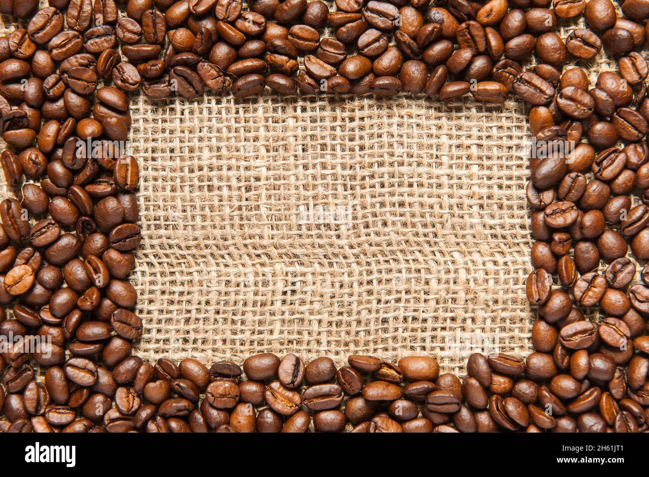 Format-filling view of a rectangular frame made of roasted coffee beans ...