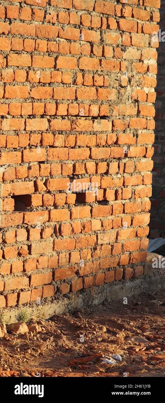 Vertical shot of a brick wall at sunset Stock Photo - Alamy