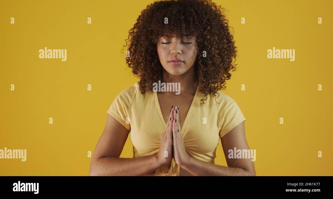 Smiling peaceful young woman practicing yoga and meditation. Calm woman ...