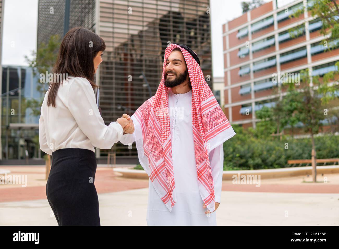 Happy smiling Arab man client and caucasian businesswoman shaking hands ...