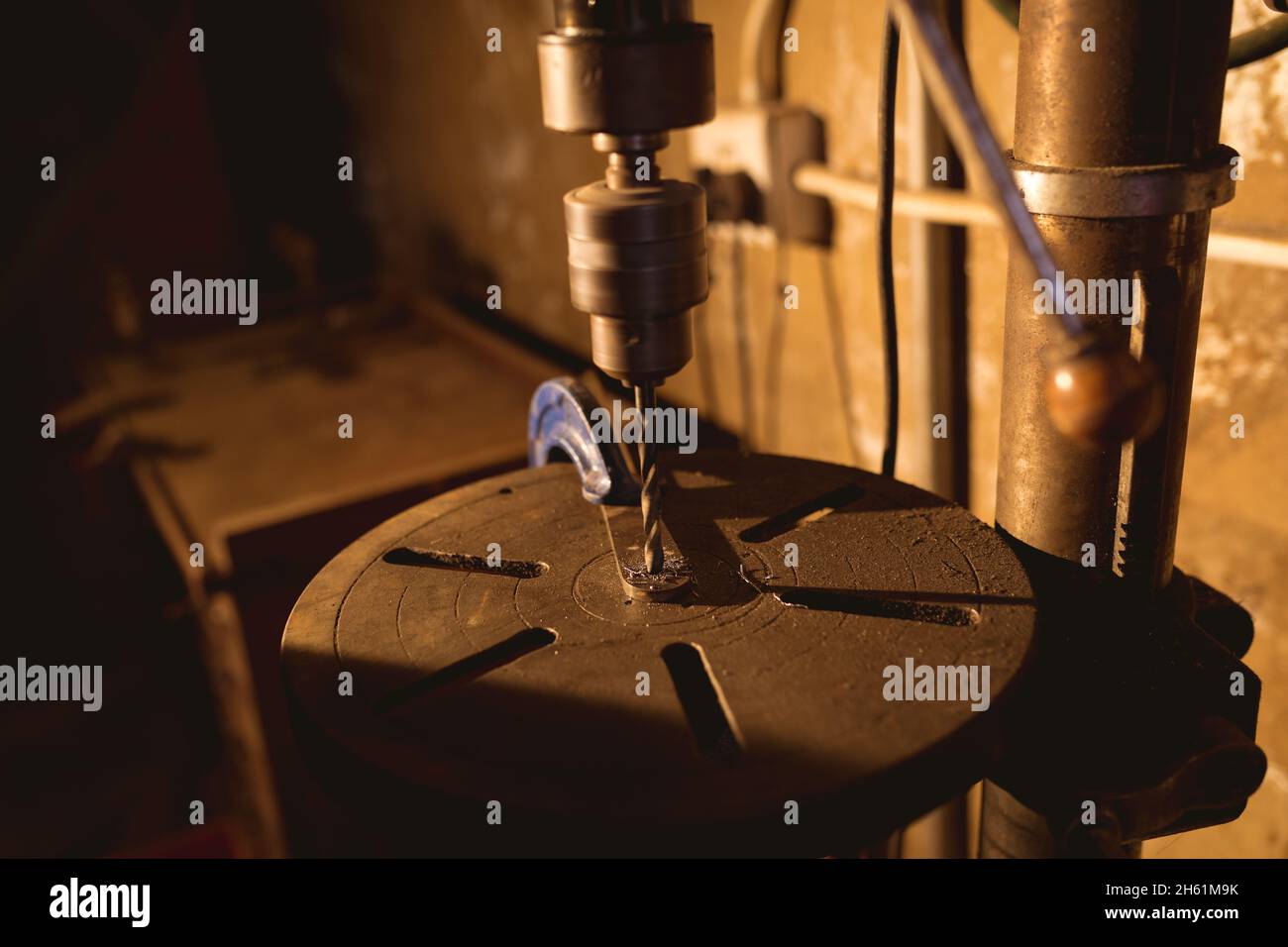 Close-up of drill making hole on metal in manufacturing industry Stock ...