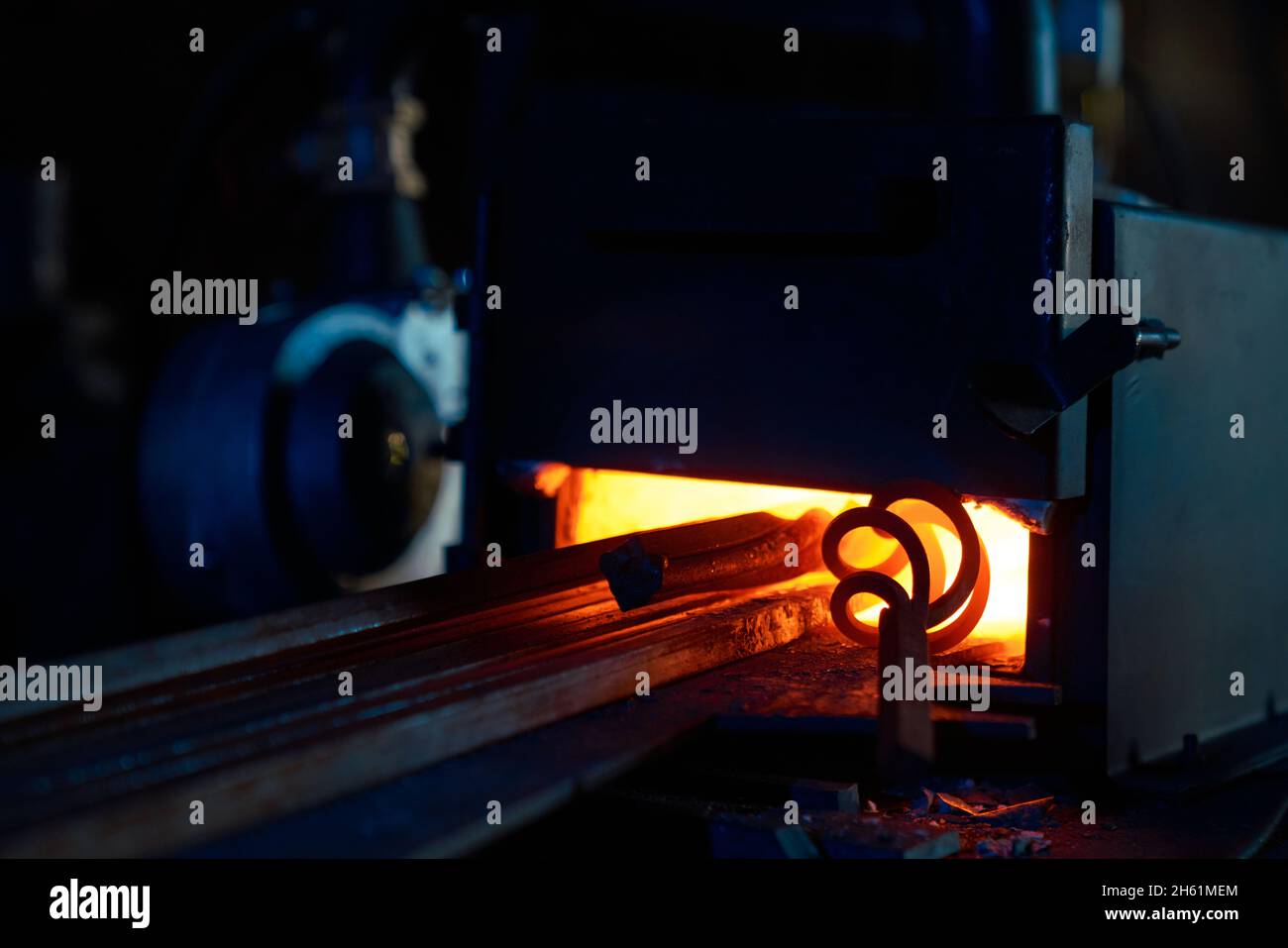 Close up of various pieces of iron heating inside forge furnace ...