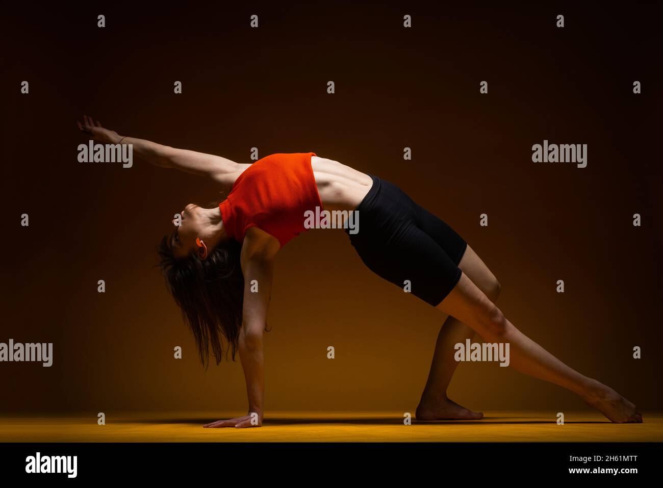 Beautiful ballerina is doing a bend ballet pose on the ground Stock ...