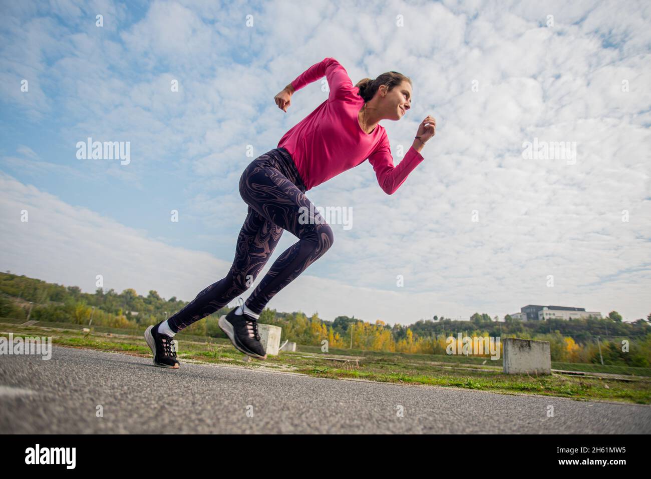 Attractive and beautiful fit girl is starting her expolsive running in ...