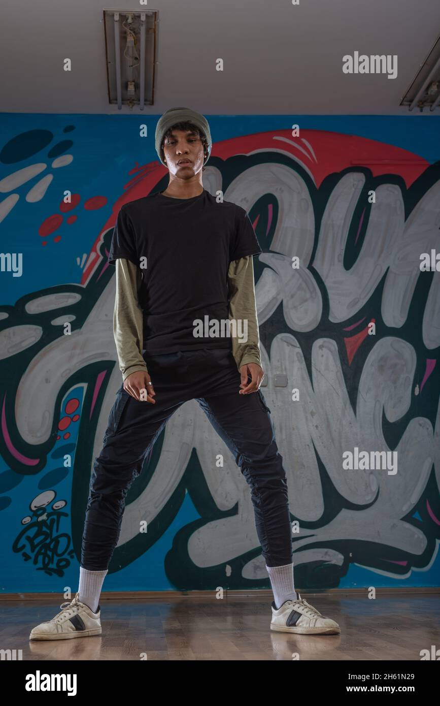 Modern rapper dancing in garage. Urban lifestyle, hip hop Stock Photo ...