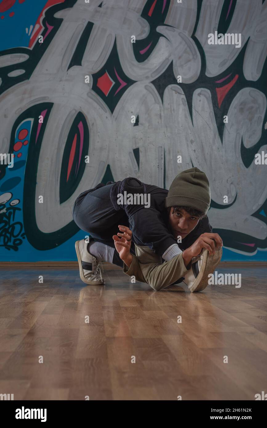 Modern rapper dancing in garage. Urban lifestyle, hip hop Stock Photo ...