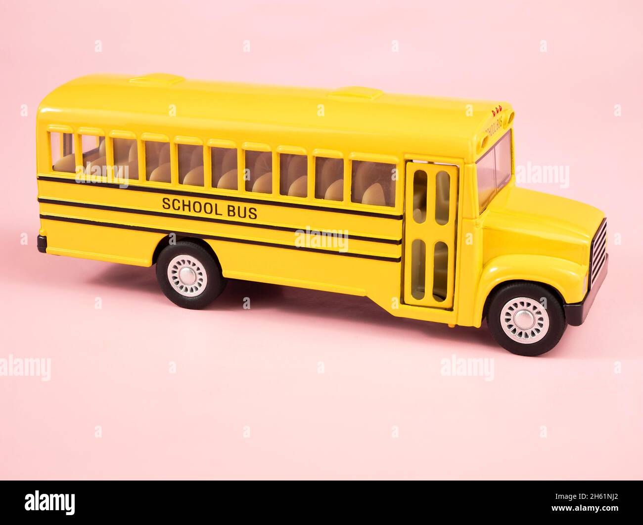 School Bus on a pink background Stock Photo - Alamy