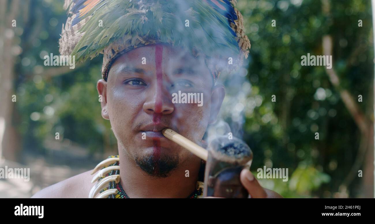 Indian chief from the Pataxó tribe smoking pipe . Brazilian Indian with ...