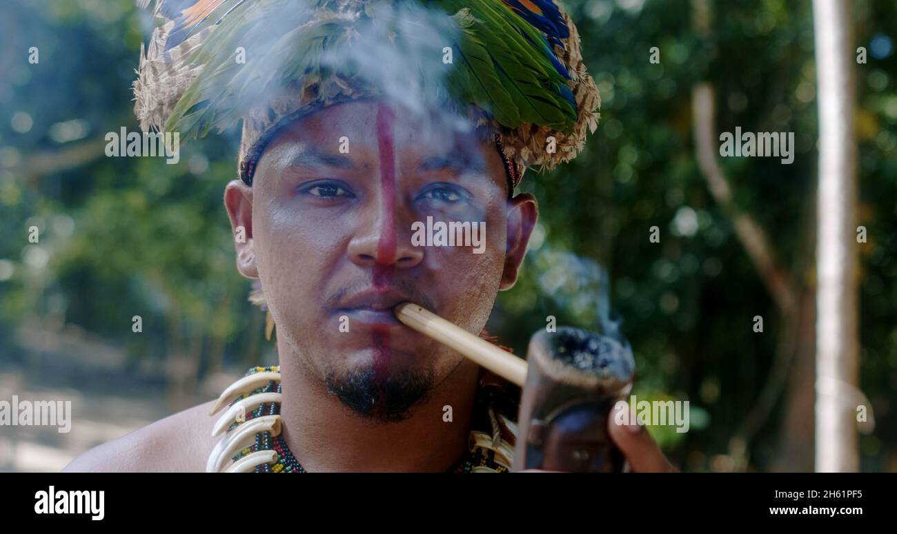 Indian chief from the Pataxó tribe smoking pipe . Brazilian Indian with ...