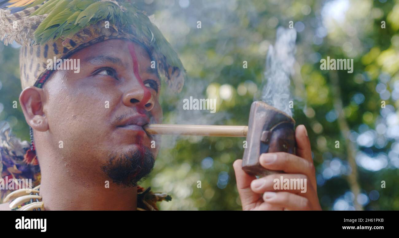 Indian chief from the Pataxó tribe smoking pipe . Brazilian Indian with ...