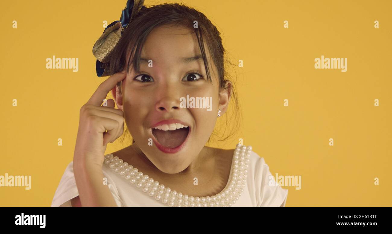 Asian child has an idea. Japanese child pointing to the head. Had a ...