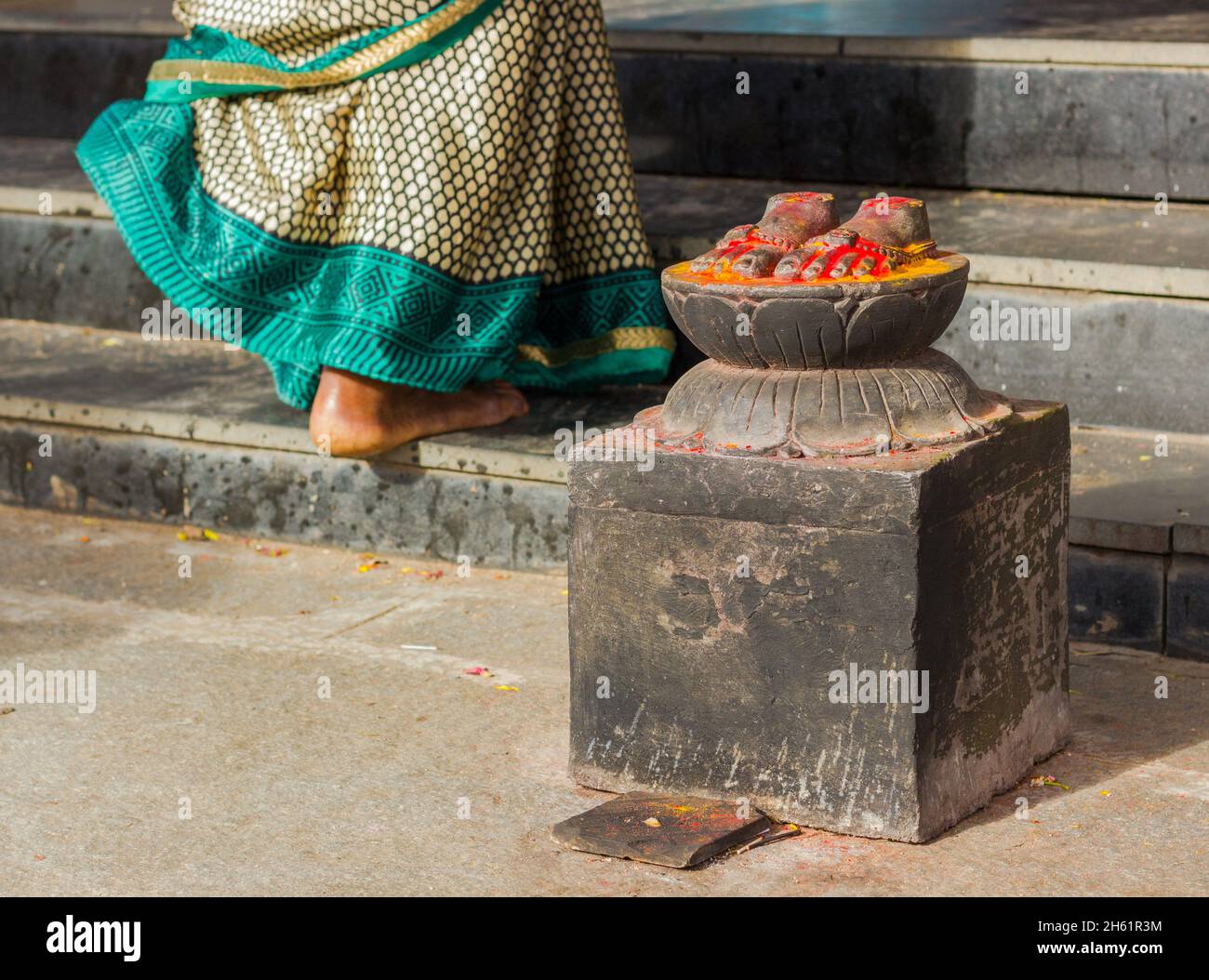 Indian woman in traditional saree walking upstairs passing by the feet ...